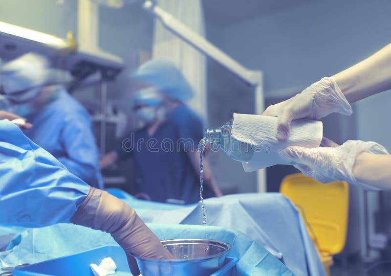 Assistant Pours Sterile Solution during Surgery Stock Image - Image of pouring, occupation: 78753543
