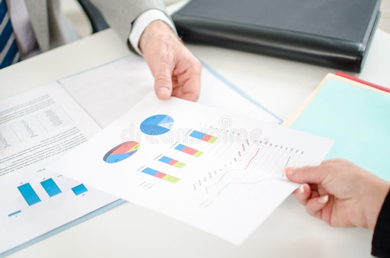 Assistant Showing Graphs To Her Boss Stock Photo - Image of teamwork ...