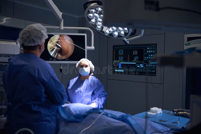 Assistant and a Surgeon Communicate, Coordinating Their Actions Stock ...