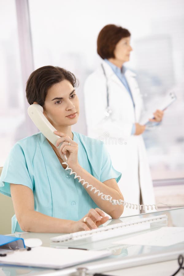 Assistant Taking Phone Call for Medical Doctor Stock Image - Image of ...