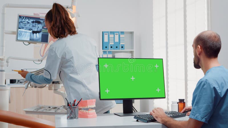 Assistant Using Horizontal Green Screen on Computer Stock Photo - Image ...