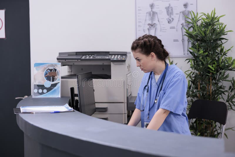Assistant Working at Reception Counter Checking Medical Expertise on ...