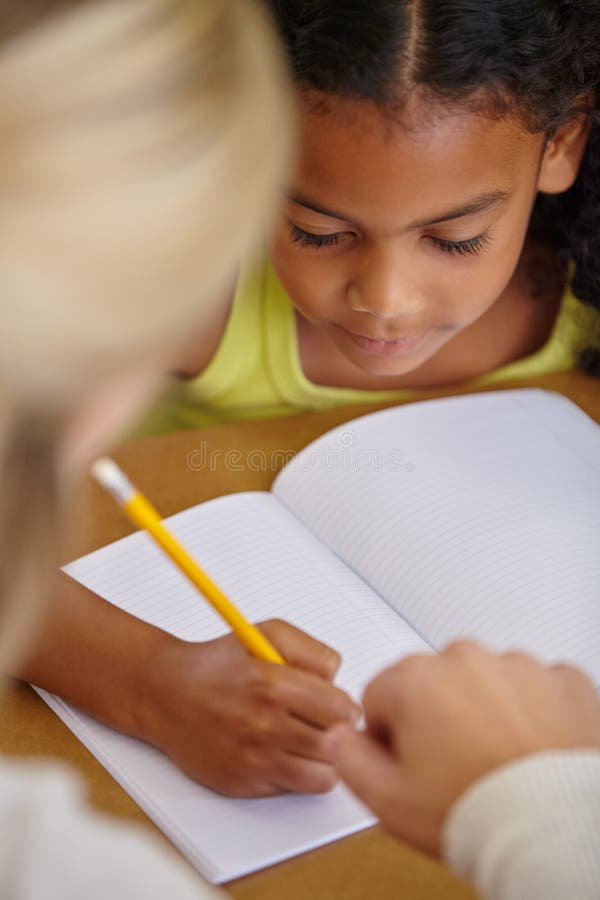 Assisting Her Students. a Teacher Explaining Something To a Student in ... Assisting Her Students. a Teacher Explaining Something To a Student in ...
