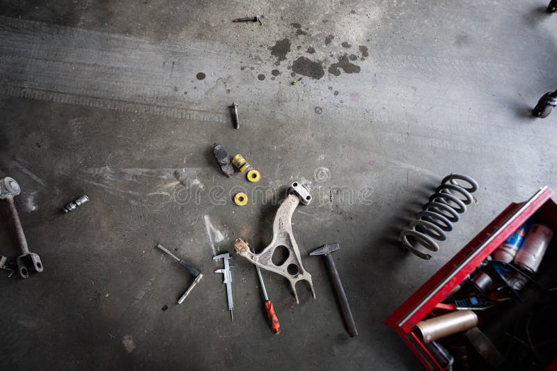 Assorted Car Parts and Tools on a Concrete Garage Floor Stock Image ...