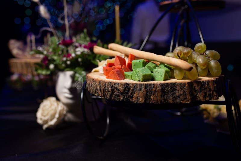 Assorted Cheese and Grapes on a Wooden Stand at the Event Stock Image ...