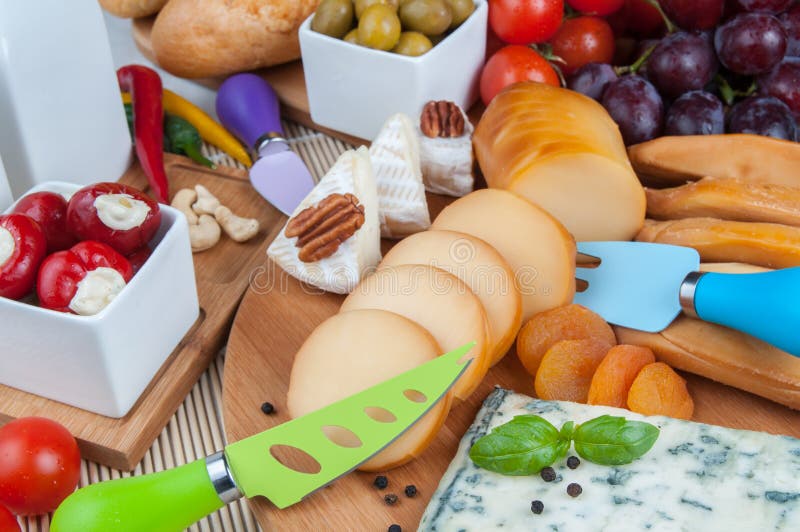 Assorted cheese on table stock photo. Image of board - 74417960
