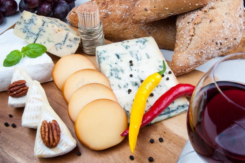 Assorted cheese on table stock photo. Image of basil - 74417968