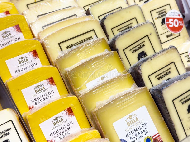 Assorted Cheeses Display with Labels and Discount Sign in Grocery Store ...