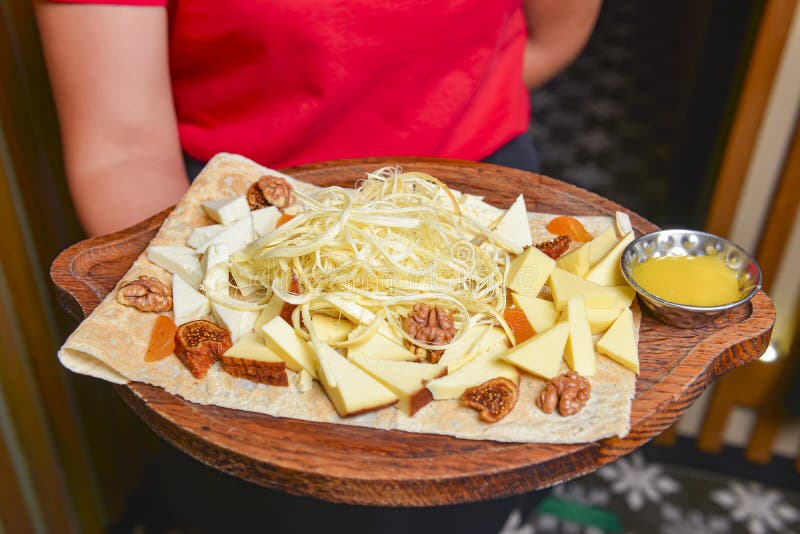 Assorted Cheeses in Various Shapes and Sizes. Waiter Serving Cheese ...