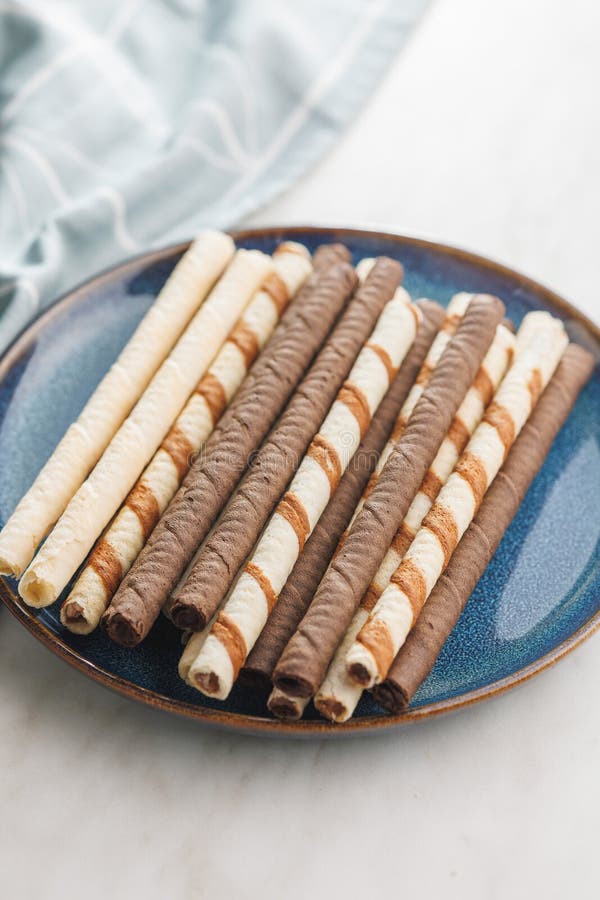 Assorted Chocolate and Vanilla Cream Filled Wafer Rolls on Plate on ...