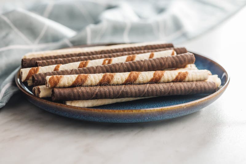 Assorted Chocolate and Vanilla Cream Filled Wafer Rolls on Plate on ...