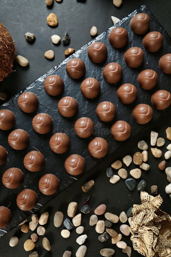 Assorted Chocolates and Nuts on a Black Surface Stock Photo - Image of ...