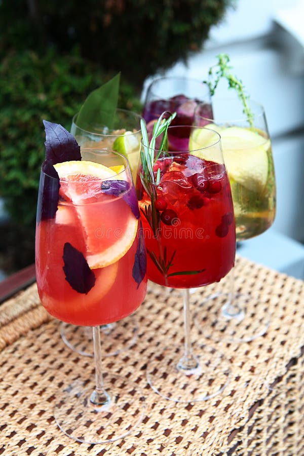 Assorted Cold Drinks in Tall Glasses. Lemonades on a Wicker Table ...