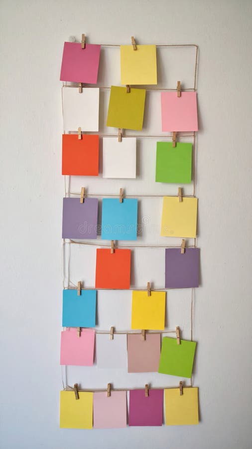Assorted Color Notes Clothespin Message Board on White Wall Background ...