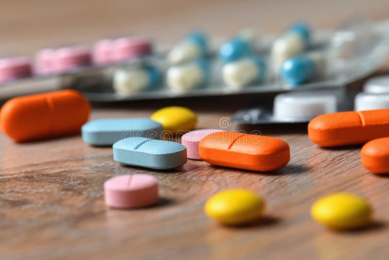 Assorted Colored Tablets and Tablet Packaging Close-up on the Table ...
