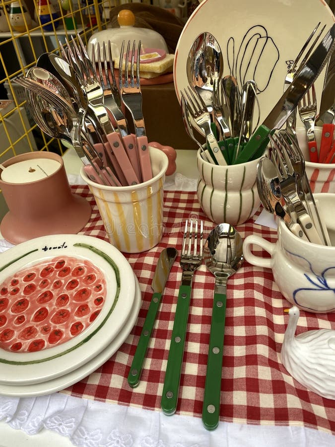 Assorted Cutlery and Crockery Arranged on Checkered Table for Kitchenware and Dining Concept ...