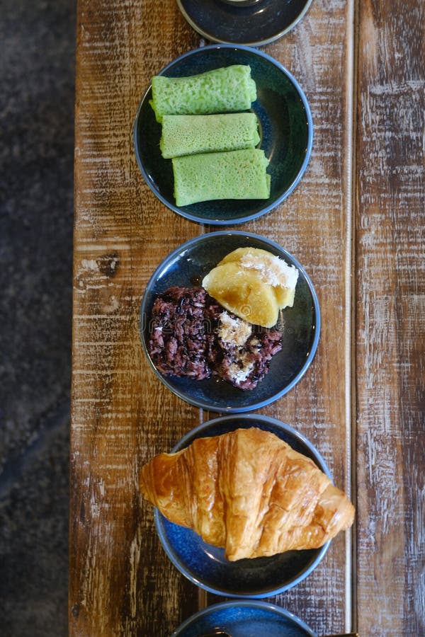 Assorted Desserts and Coffee on Table – Croissant, Balinese Sweets, and ...