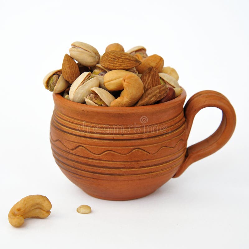 Assorted Different Nuts in a Clay Mug on a White Background. Side View ...