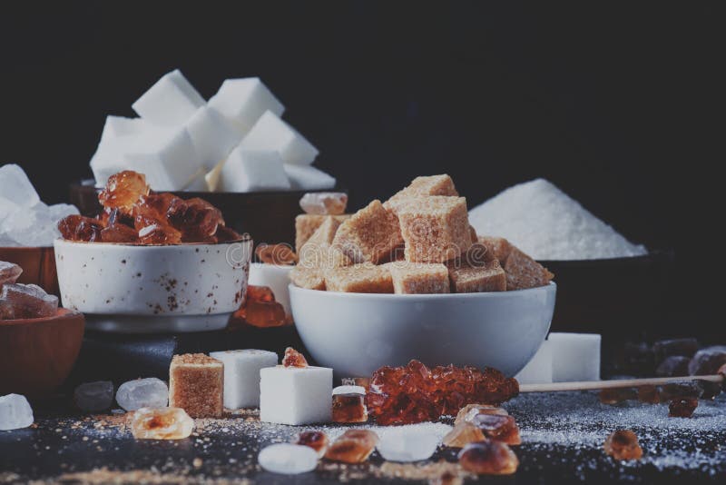 Assorted Different Types of Sugar in Bowls on a Table on a Dark Stock ...