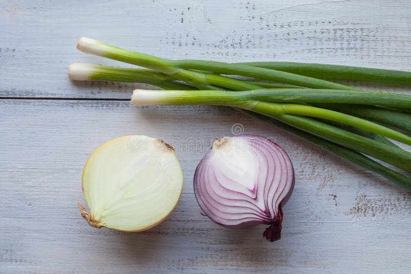Assorted Farm Fresh Onions on a Wooden Table with Spring Onions Stock ...