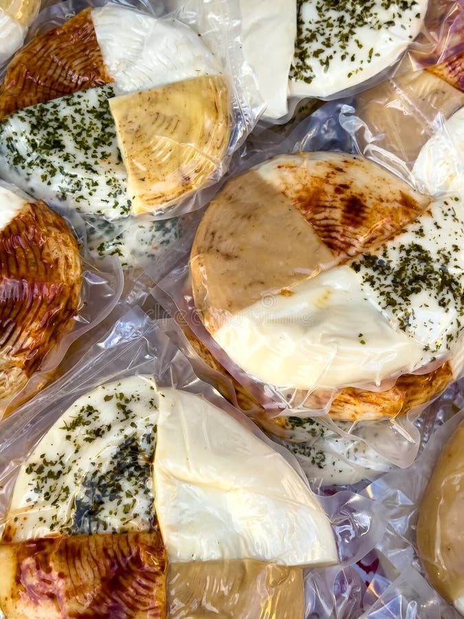 Assorted Flavored Cheese Wheels in Vacuum Packaging Stock Photo - Image ...