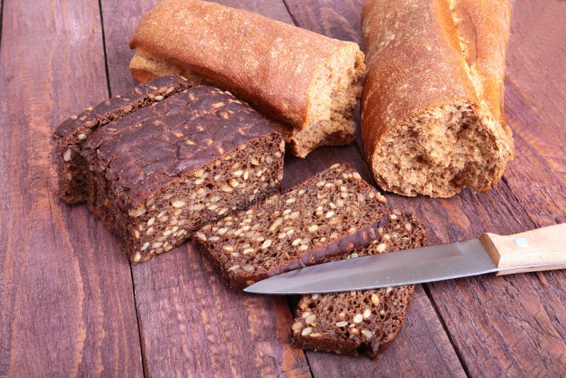 Assorted Fresh Breads, Slice and Knife Isolated on Old Wood Table ...