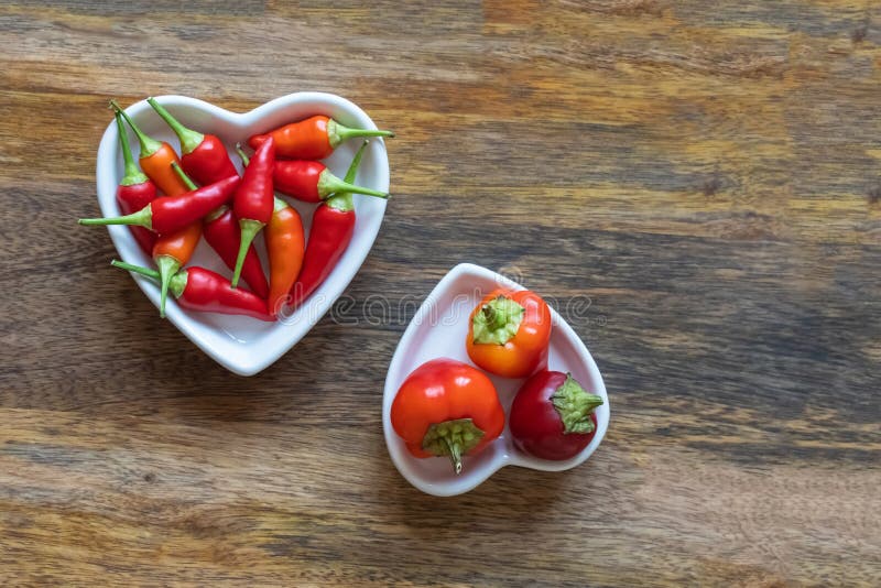 Assorted Fresh Hot Peppers Long and Round Pods on White Plates Top View ...