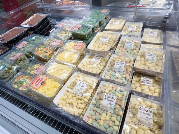 Assorted Fresh Pasta and Vegetables in Refrigerated Display at Grocery ...