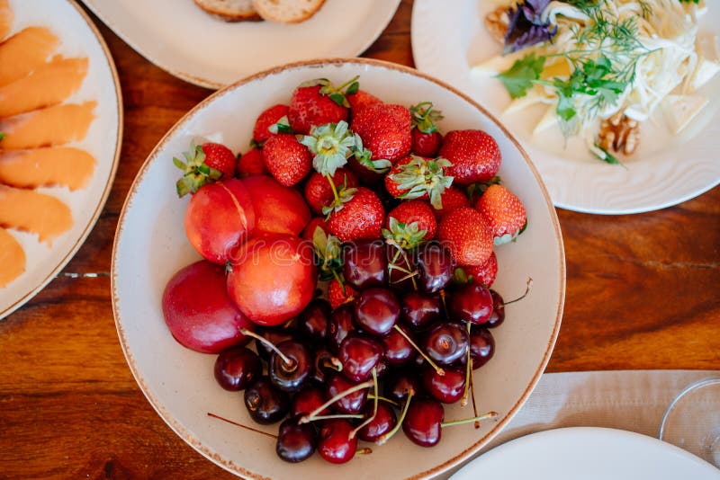 Assorted Fruit on a White Plate on the Dining Table. Stock Photo ...