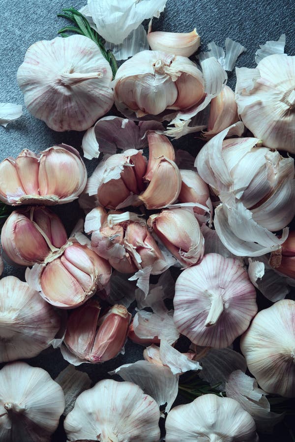 Assorted Garlic Cloves and Bulbs on Textured Background. a Dense ...