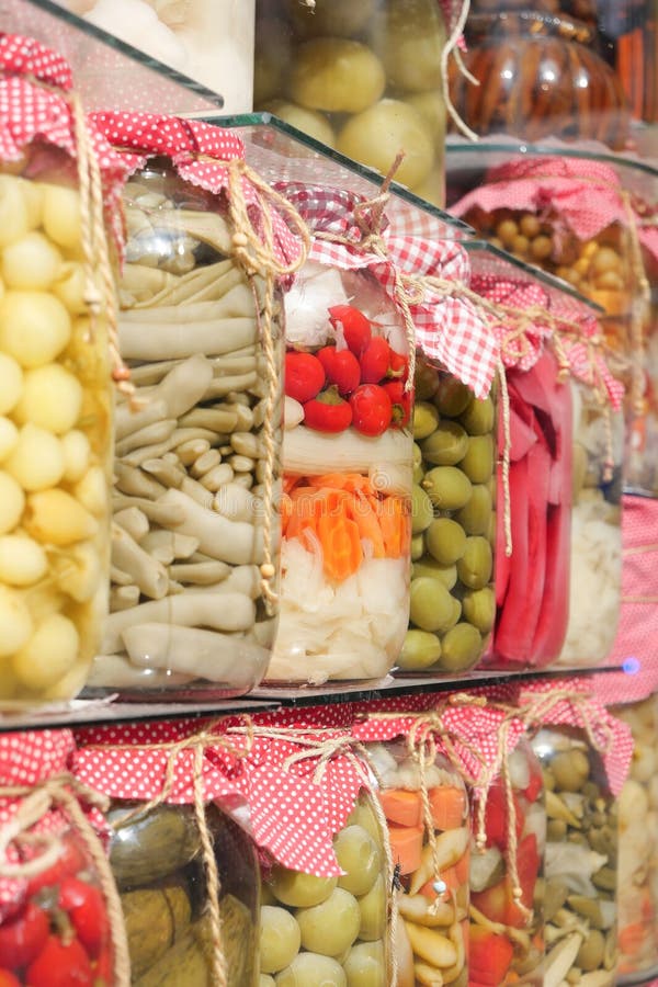 Assorted Jars of Preserved Food Items Displayed on a Shelf in a Market ...