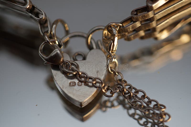 An Assortment of Keys and a Heart Shaped Lock with a Chain Stock Photo ...
