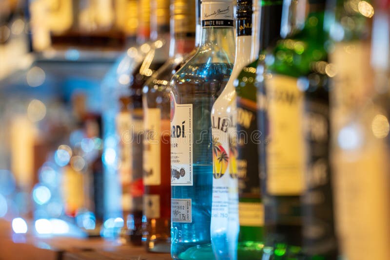 Assorted Liquor Bottles on a Bar Shelf. Editorial Stock Photo - Image ...