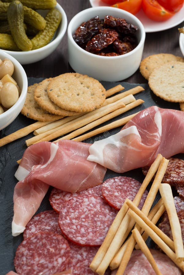 Assorted Meat Snacks, Sausages and Pickles on a Blackboard Stock Photo ...
