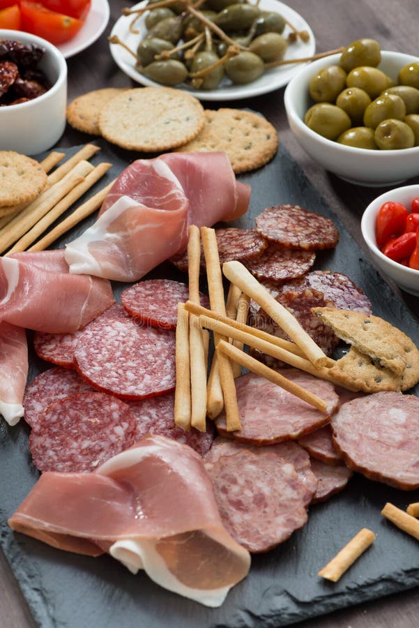 Assorted Meat Snacks, Sausages and Pickles on a Blackboard Stock Photo ...
