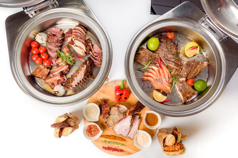 Assorted Meat with Vegetables and Sauce on a White Background Stock ...