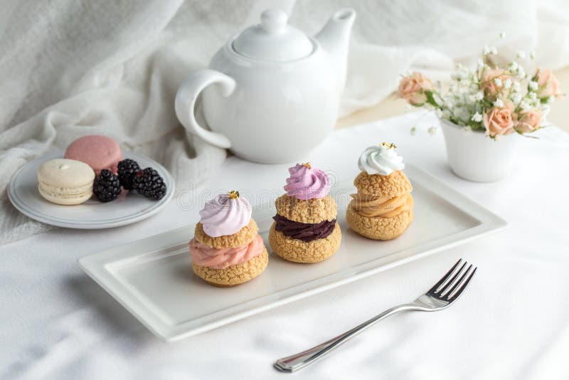 Assorted Miniature French Choux Pastry Dessert with Teapot on the Table ...