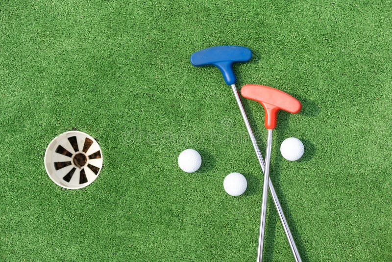 Assorted Miniature Golf Putters and Balls Askew on Synthetic Grass ...