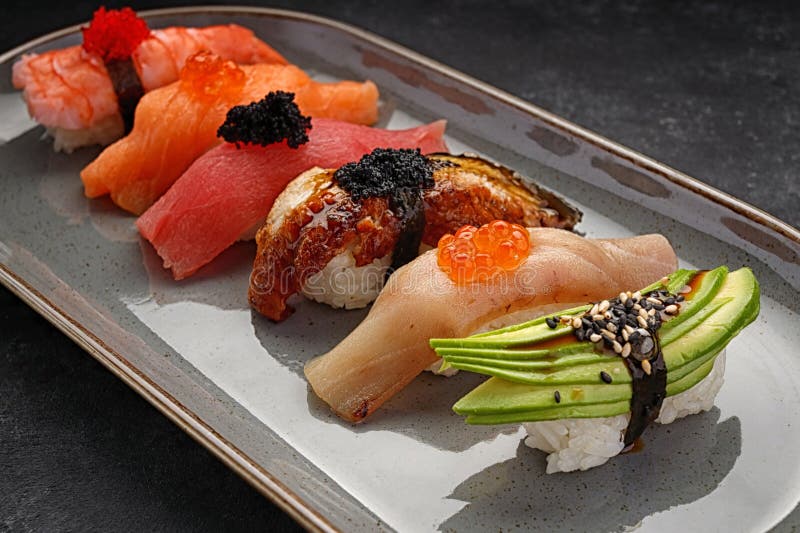 Assorted Nigiri Sushi on a Plate, on Dark Concrete Stock Photo - Image ...