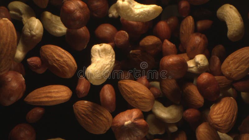 Assorted Nuts Flying in the Air in a Free Fall in Slow Motion on Black ...