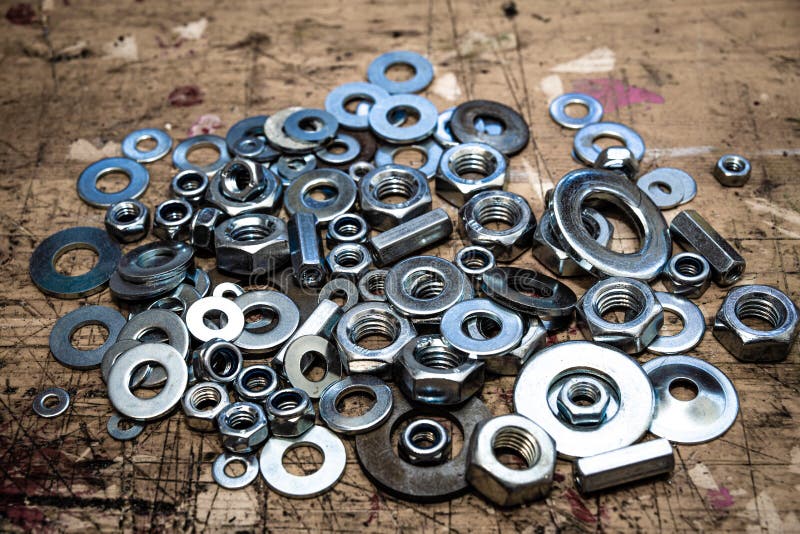 Assorted Nuts and Washers on Wooden Workbench Stained Grunge Textured ...