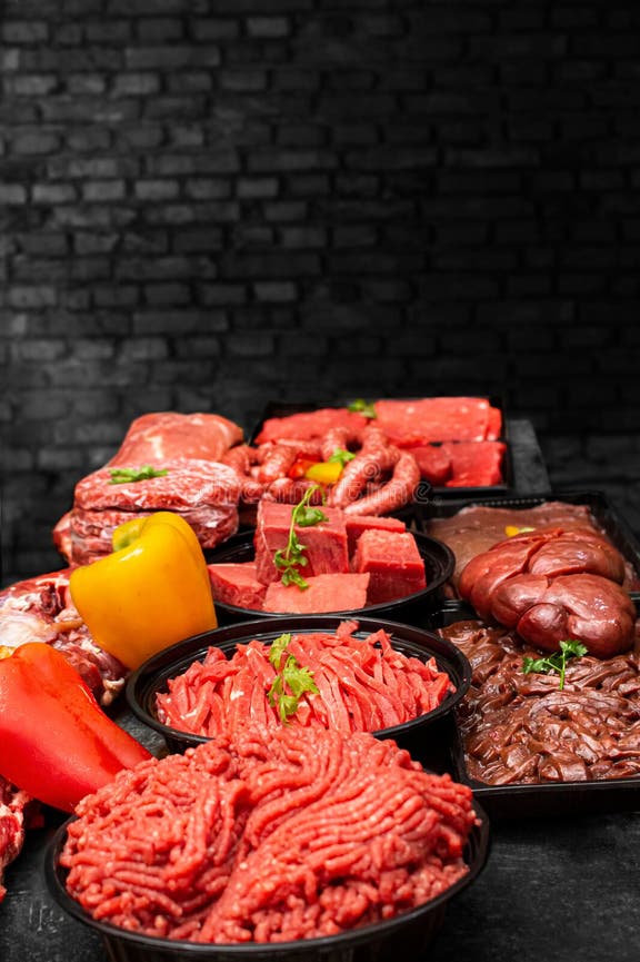Assorted Raw Beef Meats with Dark Brick Wall Background Side View Stock ...