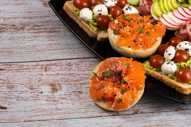 Assorted Sandwiches with Fish, Cheese, Meat and Vegetables on a Black ...