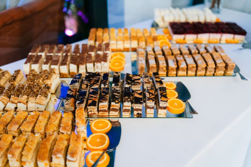 Assorted Selection of Cake Pieces, and Desserts in Trays Stock Photo ...