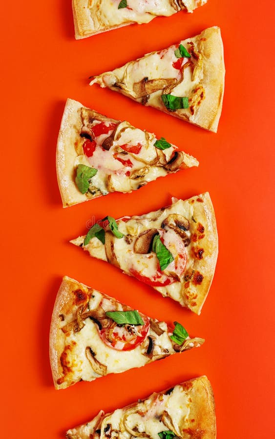 Assorted Slices of Pizza Placed Vertically on Vibrant Orange Background ...