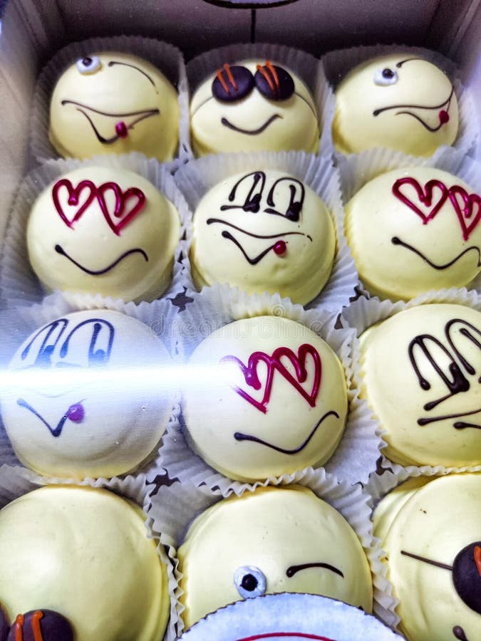 Assorted Smiley Face Cupcakes Displayed in a Box at a Bakery Stock ...