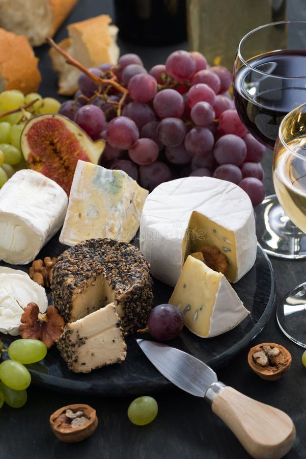 Assorted Soft Cheeses, Grapes, Nuts and Honey on a Wooden Board Stock ...