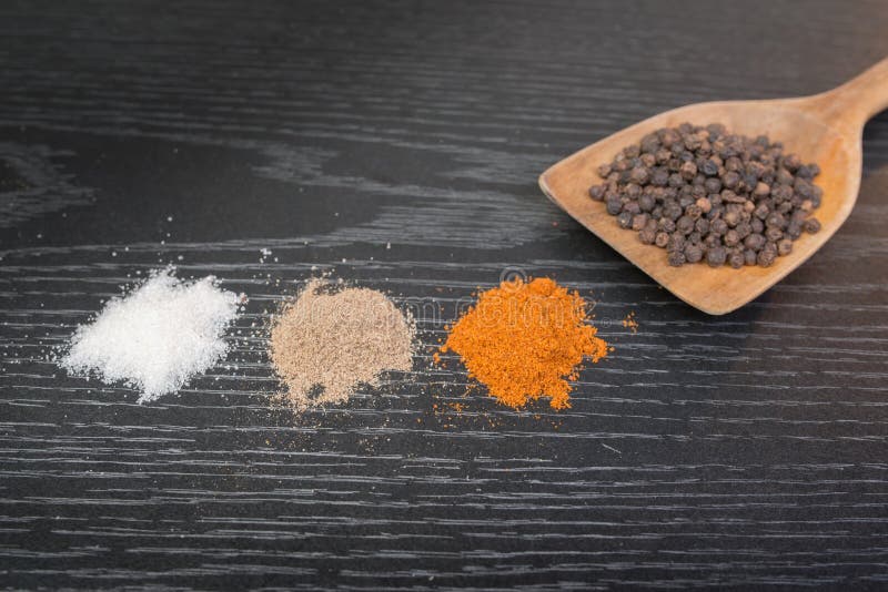 Assorted Spices and Condiments on Table Black Wooden Stock Photo ...
