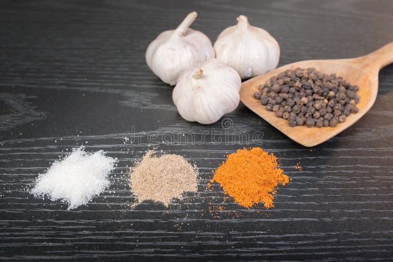 Assorted Spices and Condiments on Table Black Wooden Stock Photo ...