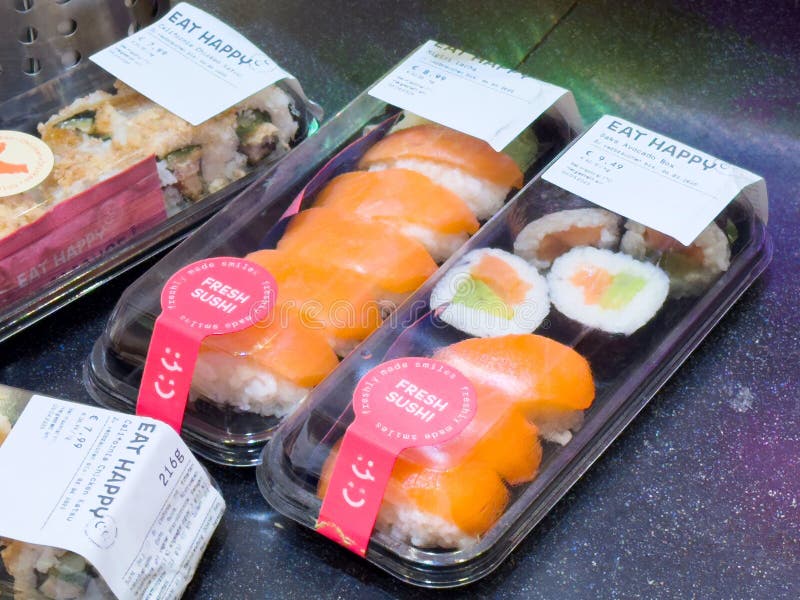 Assorted Sushi Display with Salmon and Vegetable Rolls in Packaging ...